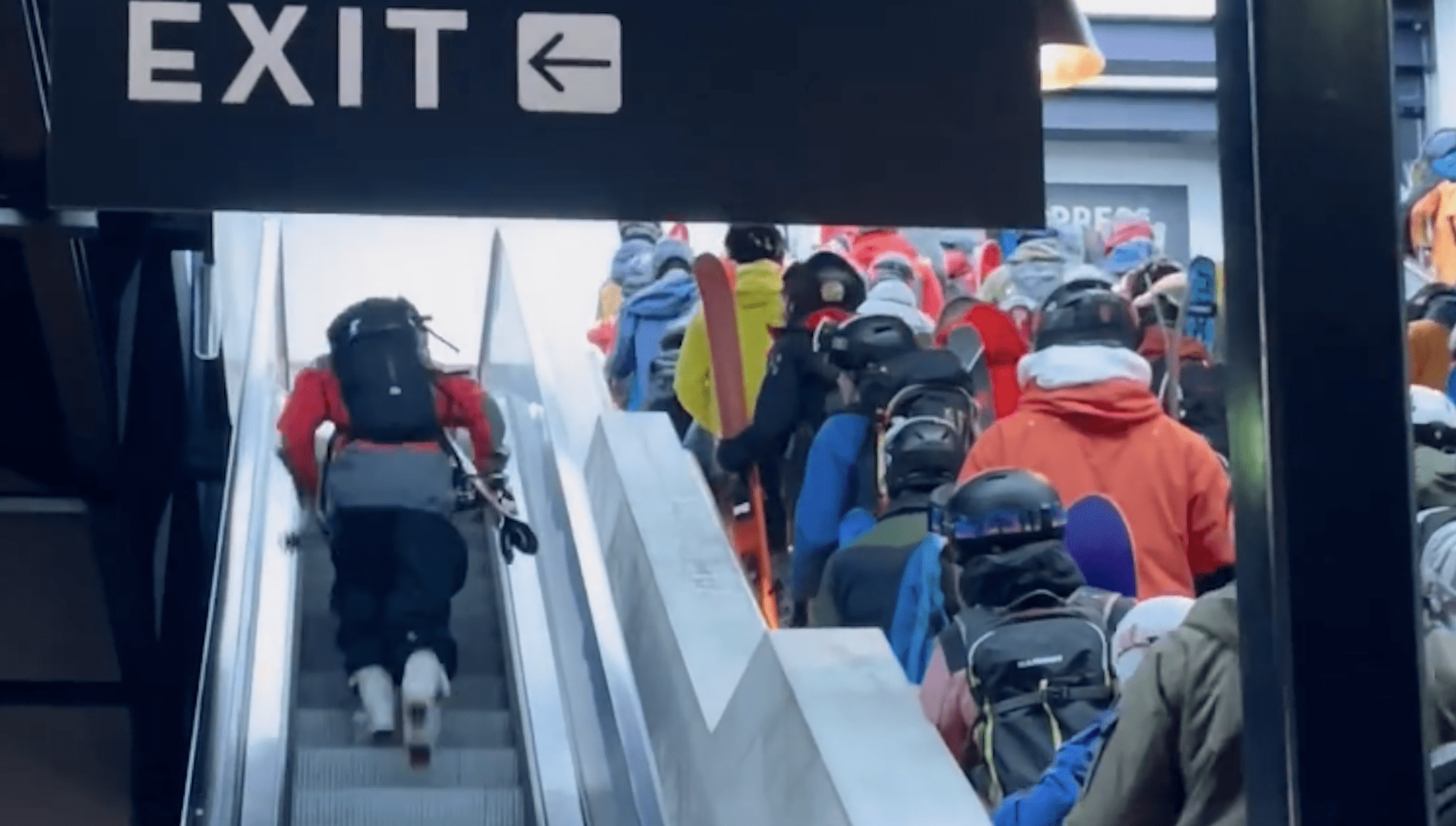 Emil Granbom Runs Up The Descending Escalator In Ski Boots
