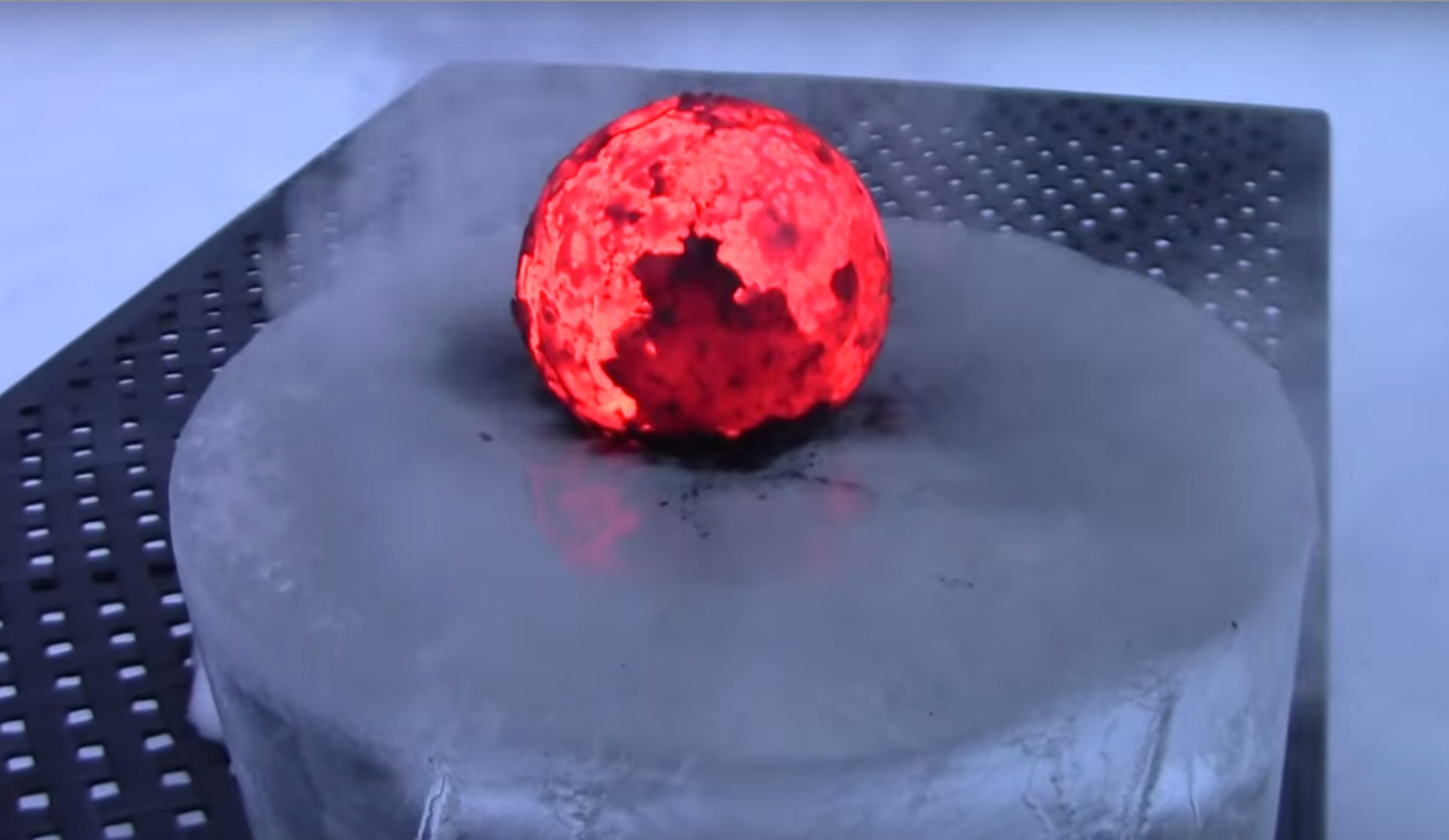 Watching This Red Hot Cannonball Melt Through A Block Of Ice Is Oddly ...