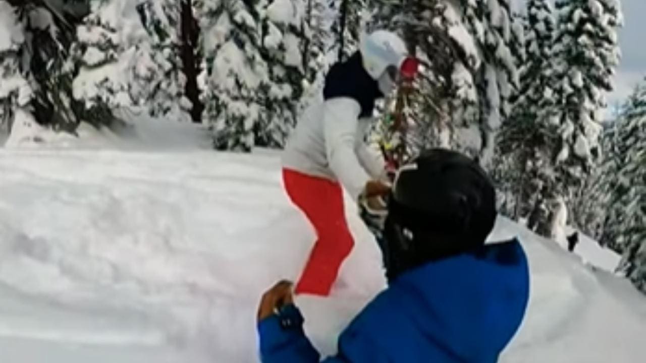 WATCH: Snowboarder Rescues Skier Stuck In Deep Snow