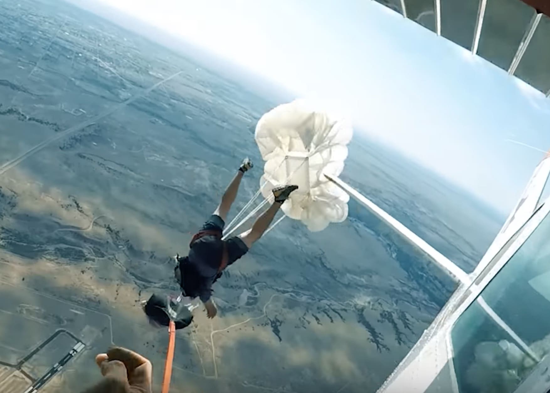 VIDEO: Premature Parachute Opening Rips Skydive Student From Plane